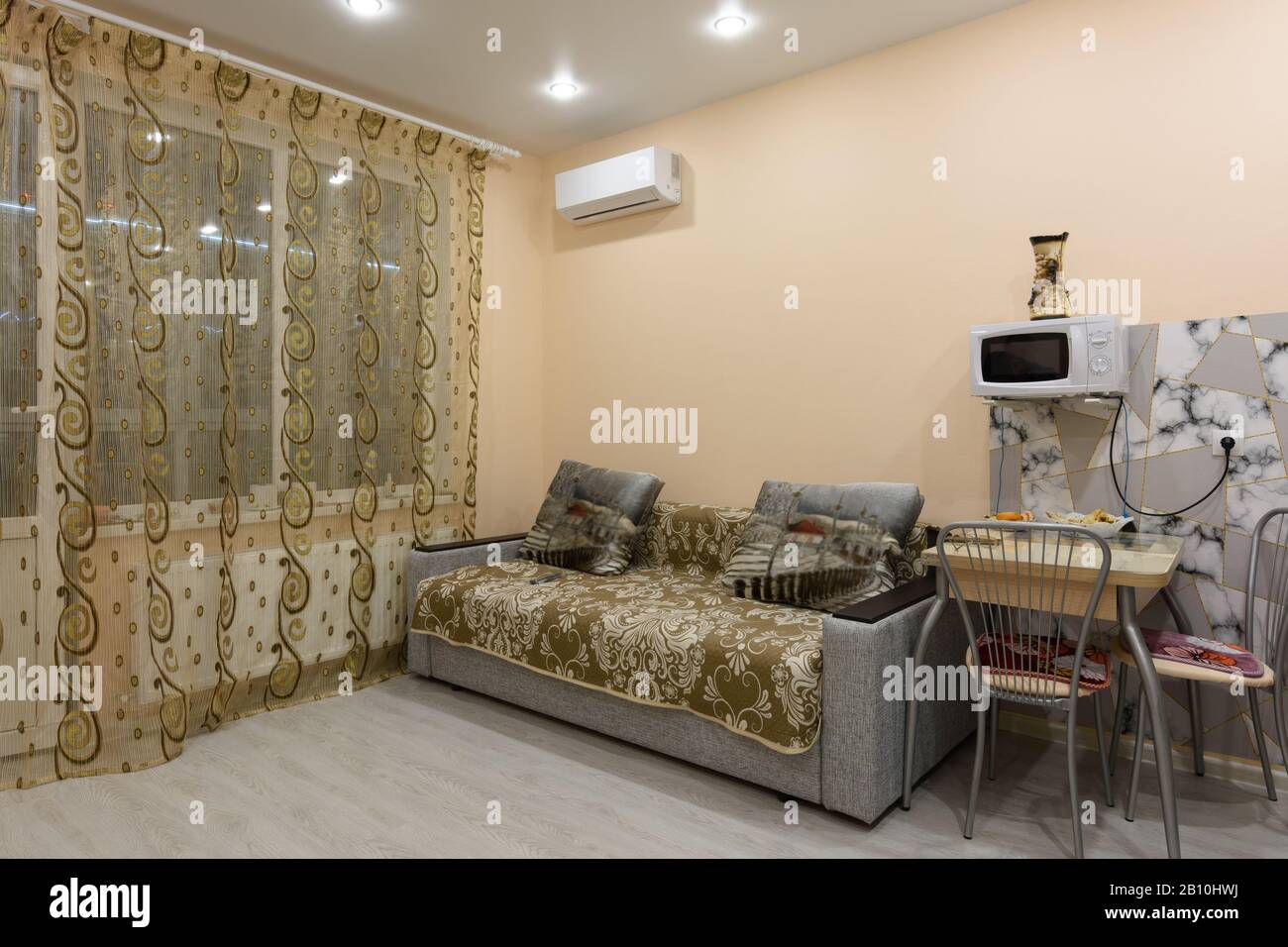 The interior of the studio apartment, a large window, a sofa and a ...