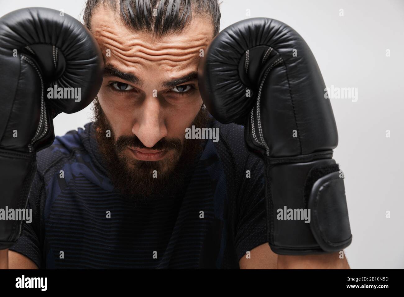 Image of young muscular sportsman wearing tracksuit boxing in gloves ...