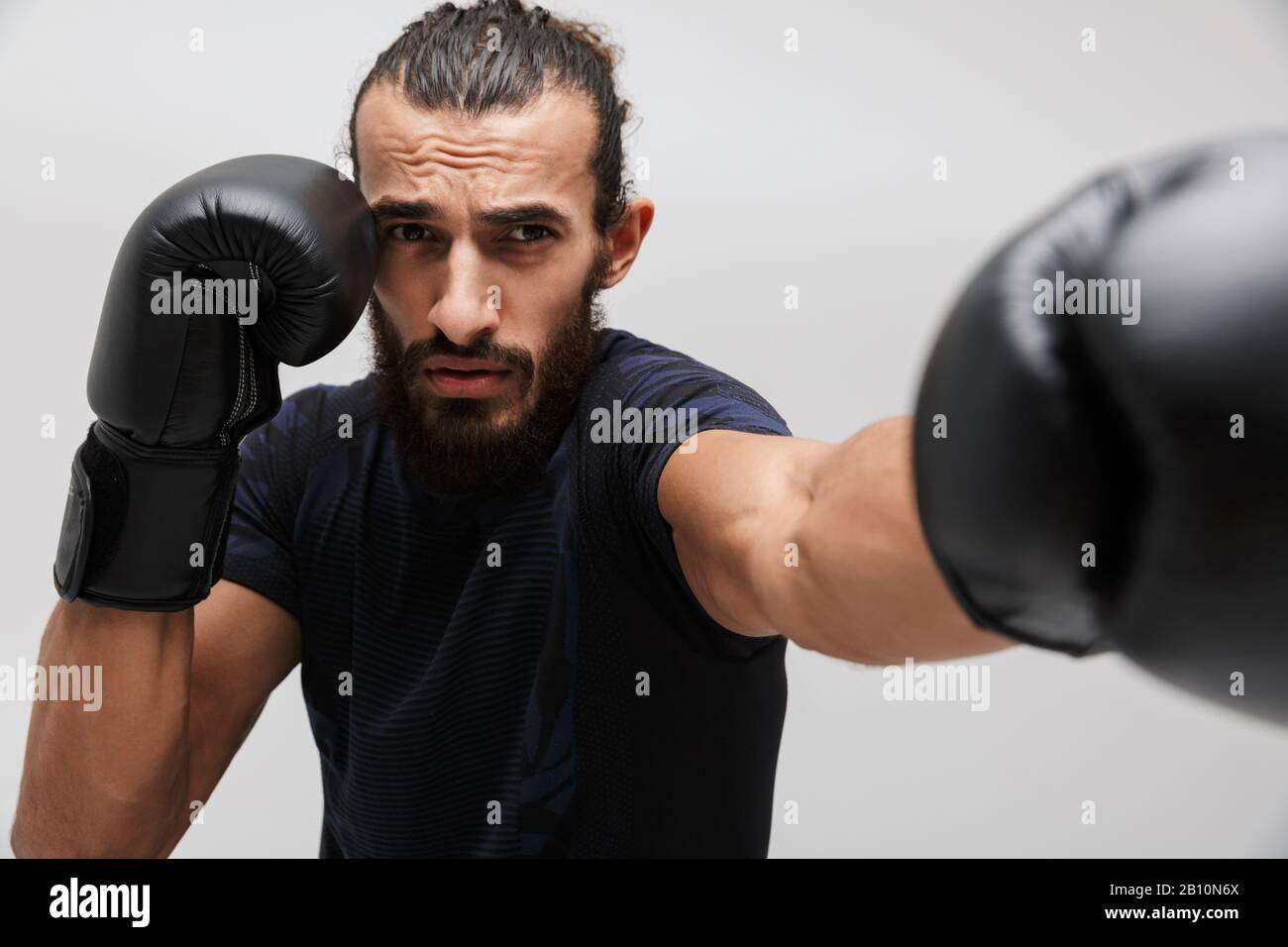 Image of athletic muscular sportsman wearing tracksuit boxing in gloves ...