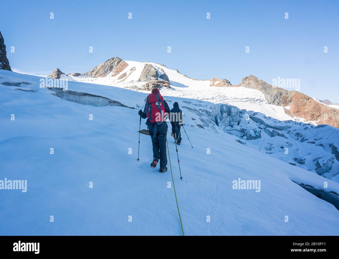 Hiking to mountain summit on snow glacier extreme trek Stock Photo - Alamy
