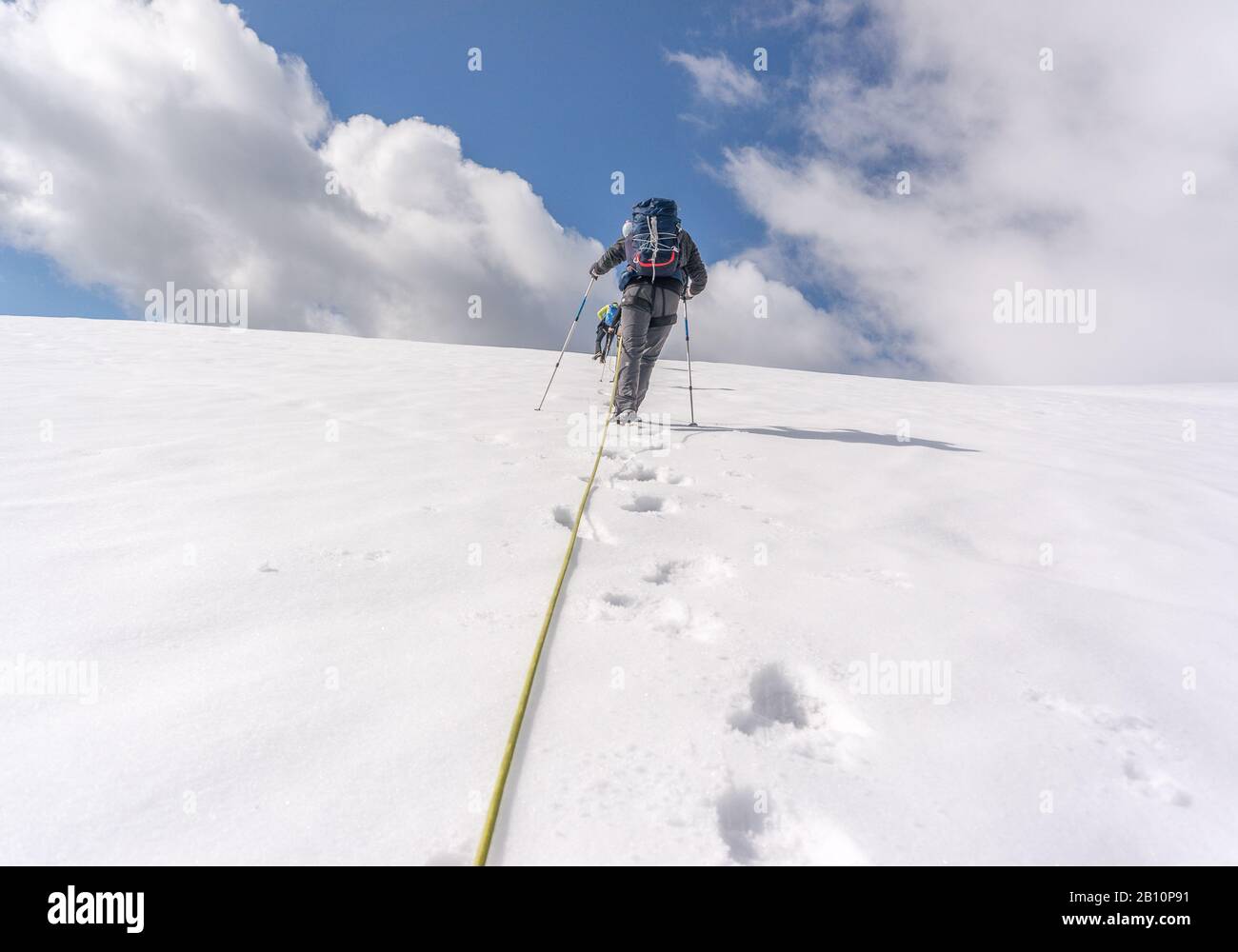 Hiking to mountain summit on snow glacier extreme trek Stock Photo - Alamy
