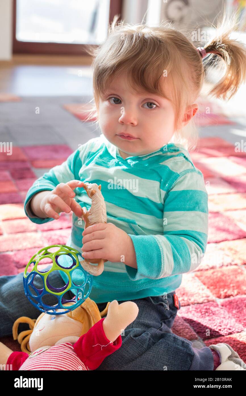 Little girl with toys Stock Photo - Alamy
