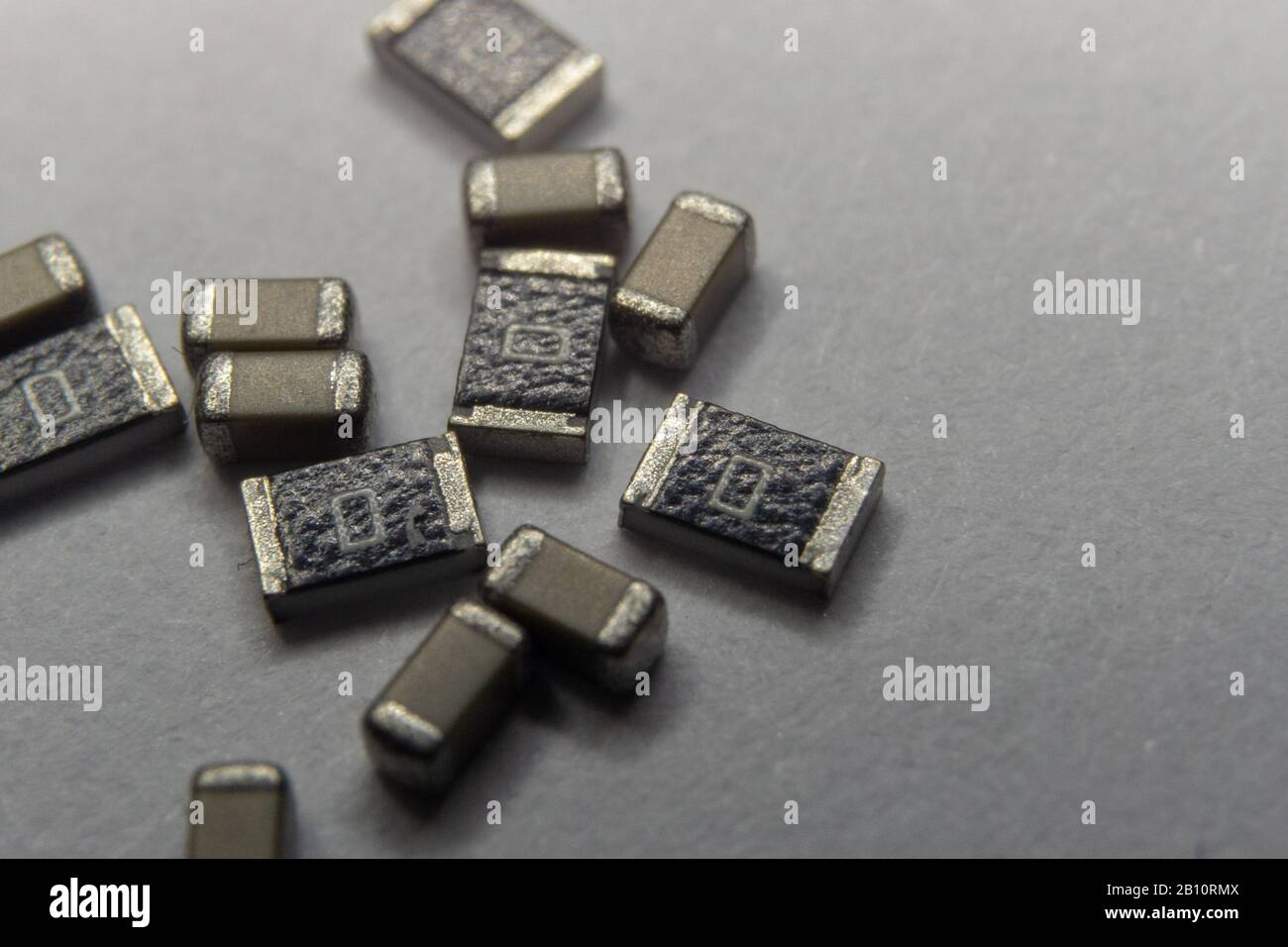 Abstract close-up of grey scattered 0603 SMT surface mount chip MLCC ...