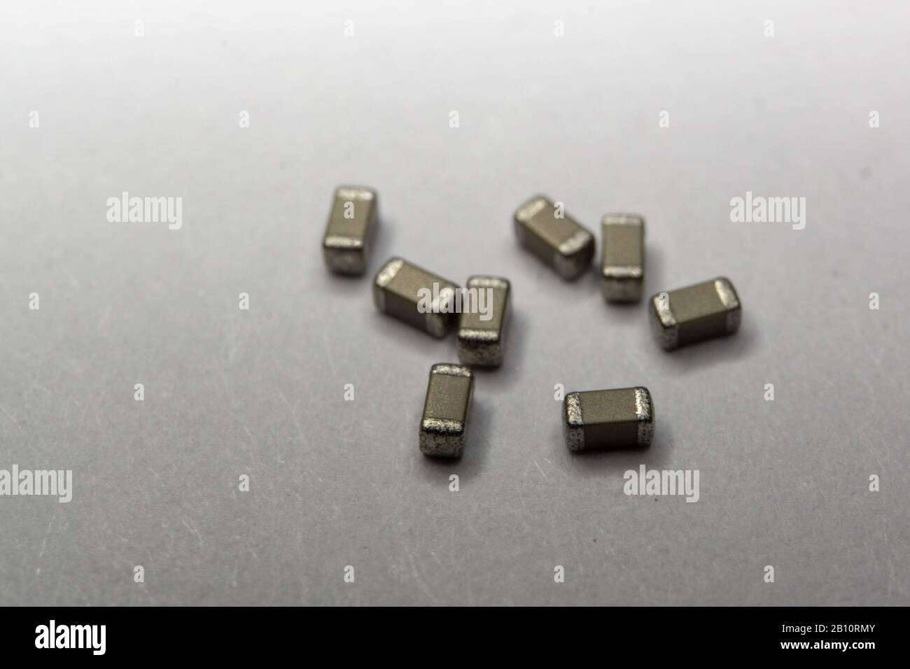 Abstract close-up of grey scattered 0603 SMT surface mount chip MLCC ...