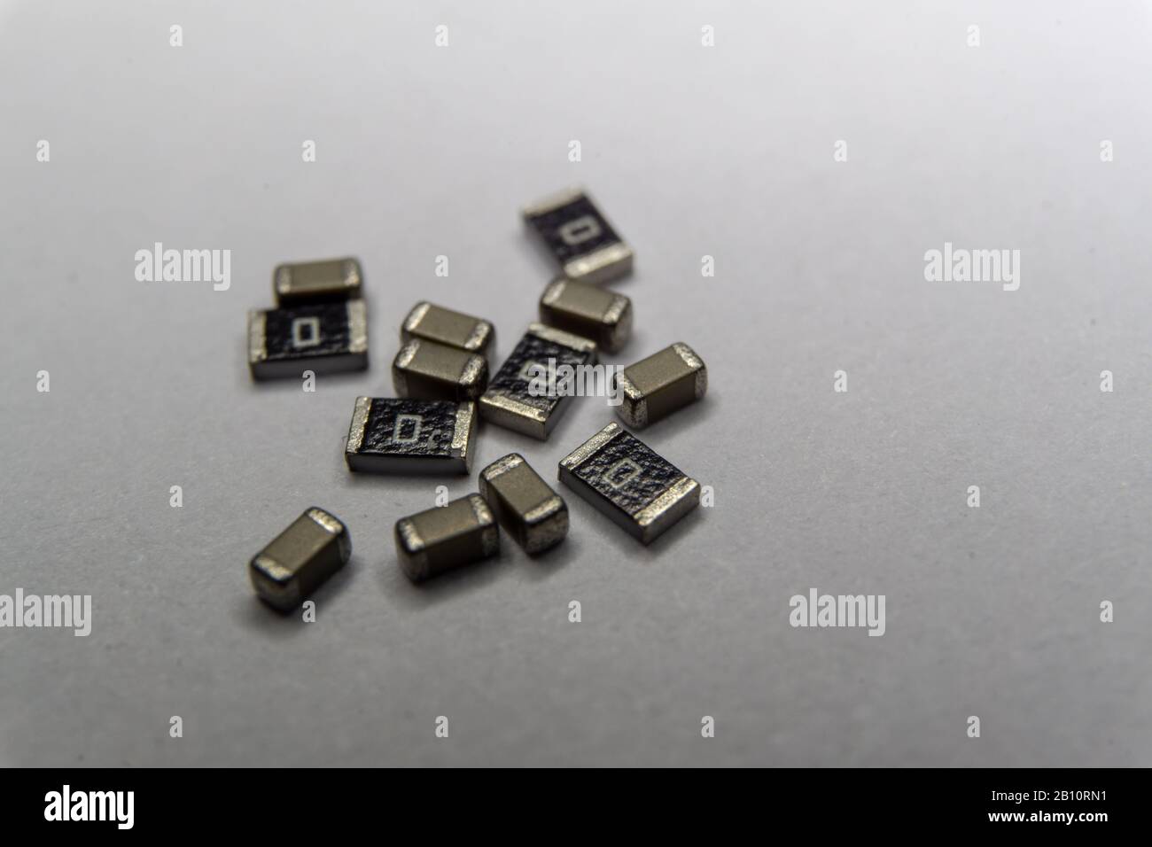 Abstract close-up of grey scattered 0603 SMT surface mount chip MLCC ...