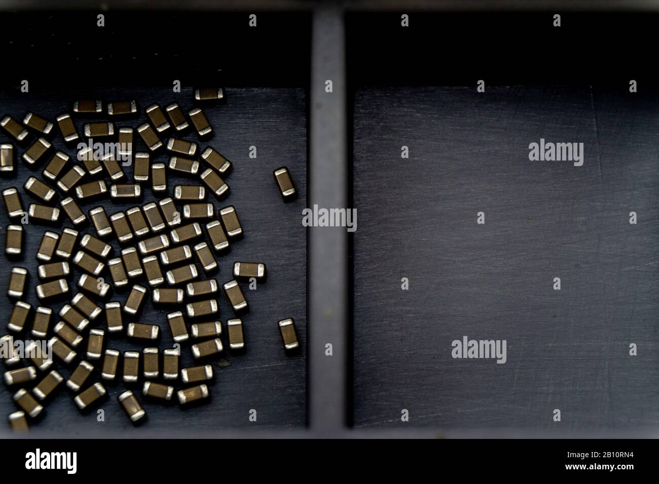 Abstract close-up of surface mount electronics components in storage ...
