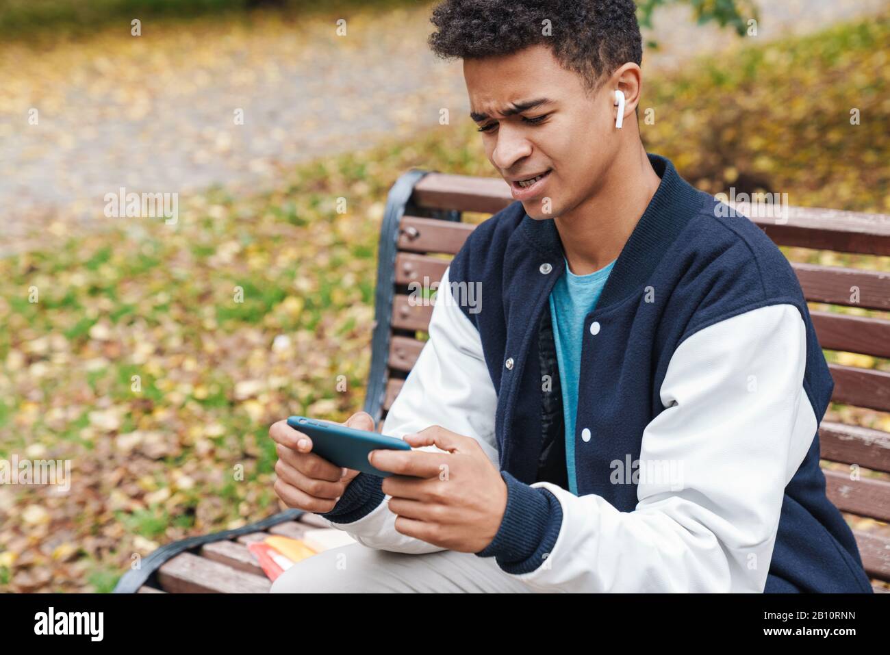 Sad boy sitting on bench hi-res stock photography and images - Alamy