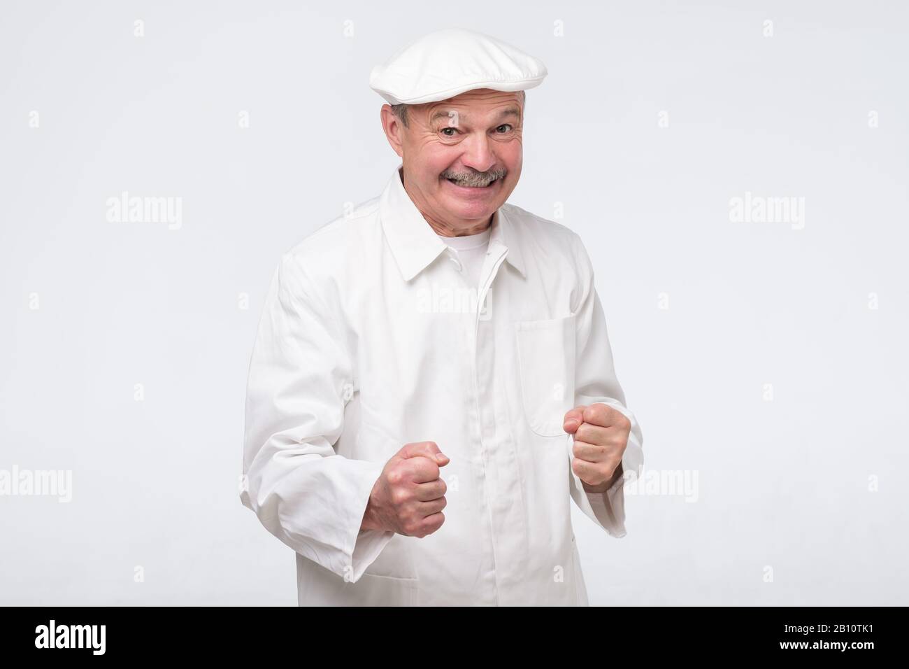 Excited chef guy in uniform is happy with success saying yes holding ...