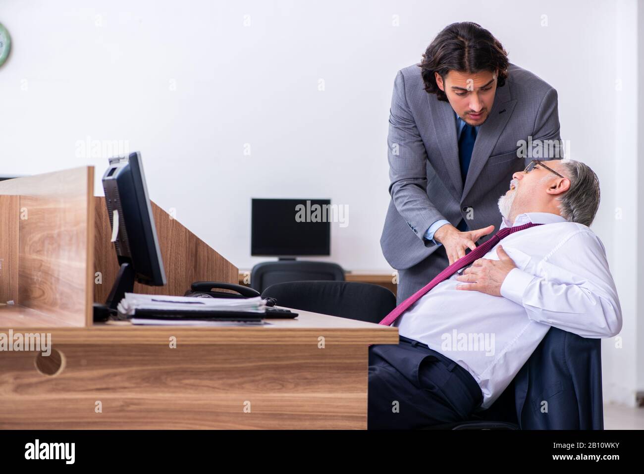 The male employee suffering from heart attack in the office Stock Photo ...
