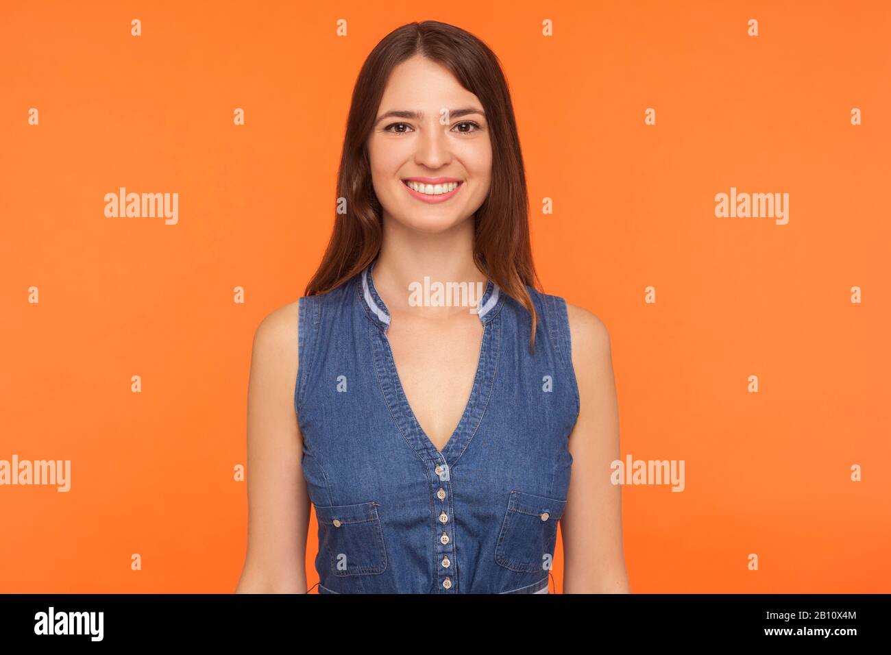 Beautiful Brunette Woman In Denim Dress Looking At Camera With Big