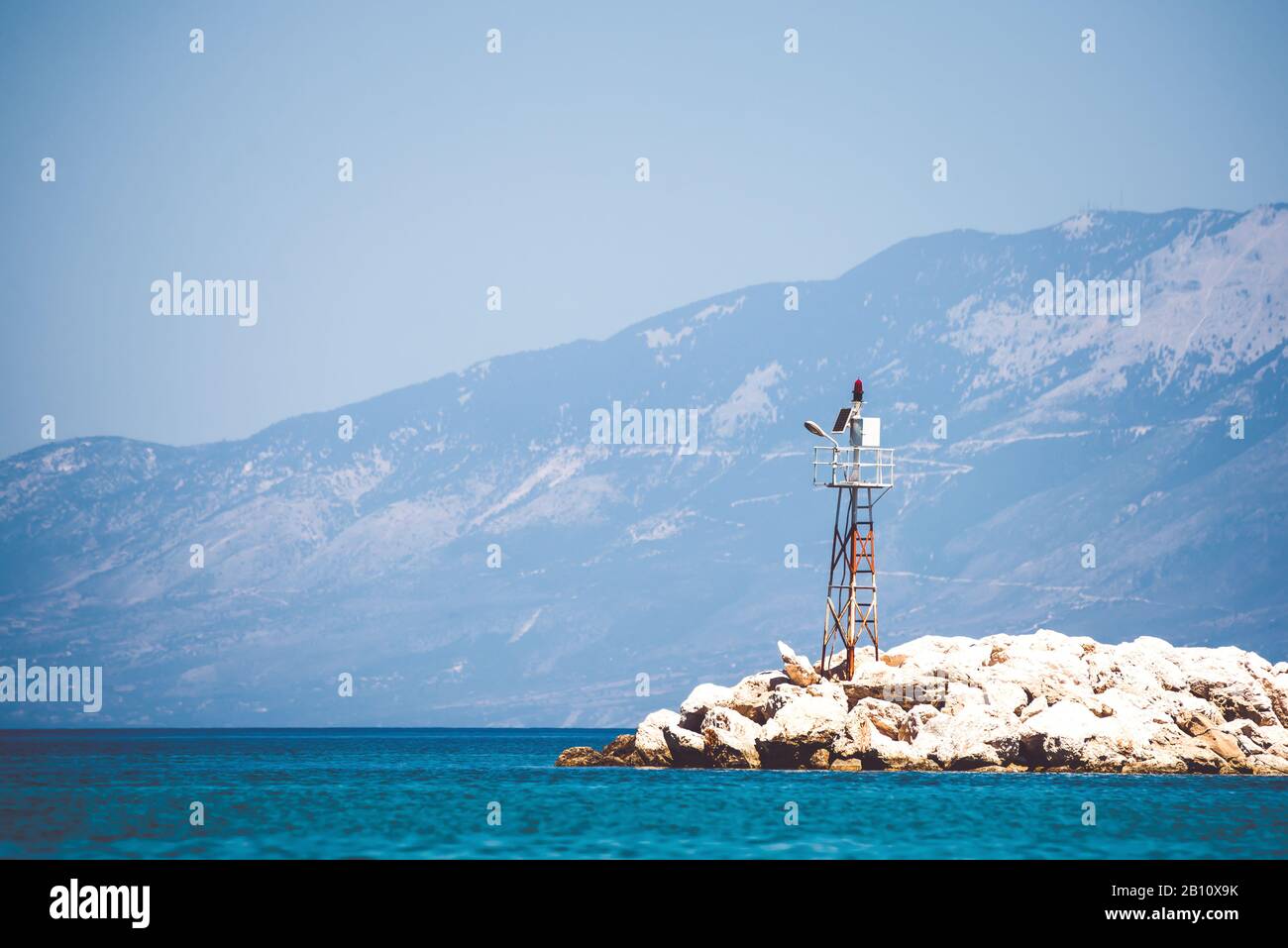 Lonely sea beacon on rocky shore. Horizontal image Stock Photo - Alamy