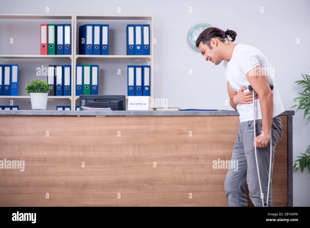 Clinic reception counter and young patient Stock Photo - Alamy