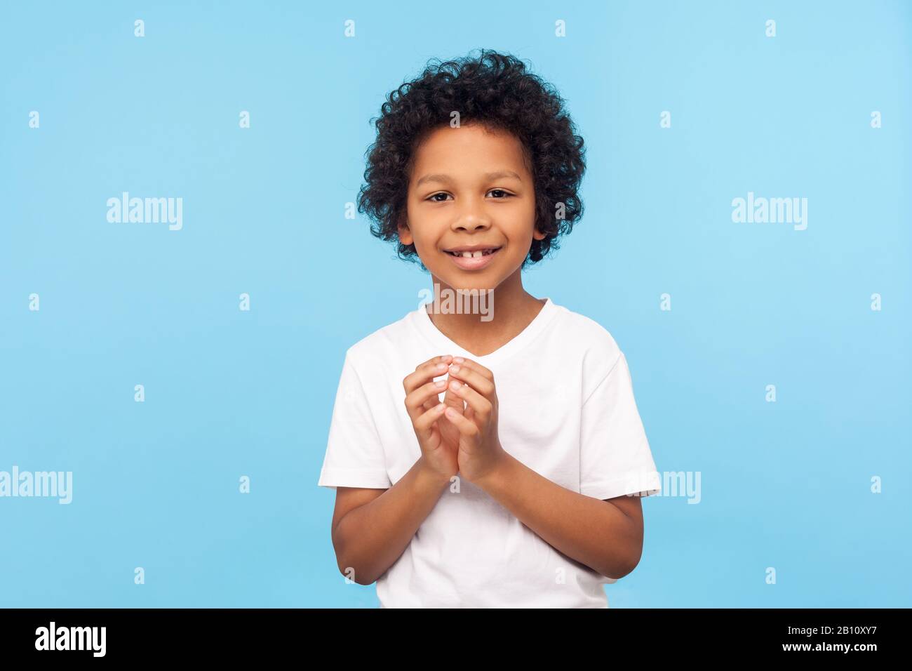 Portrait of funny devious little boy in T-shirt thinking over cunful ...