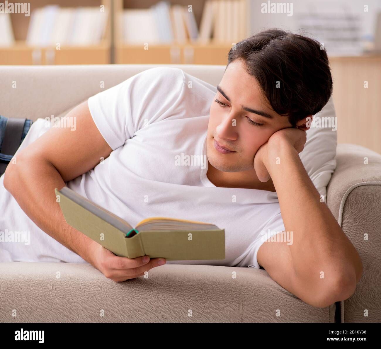 The handsome man lying on the sofa Stock Photo - Alamy