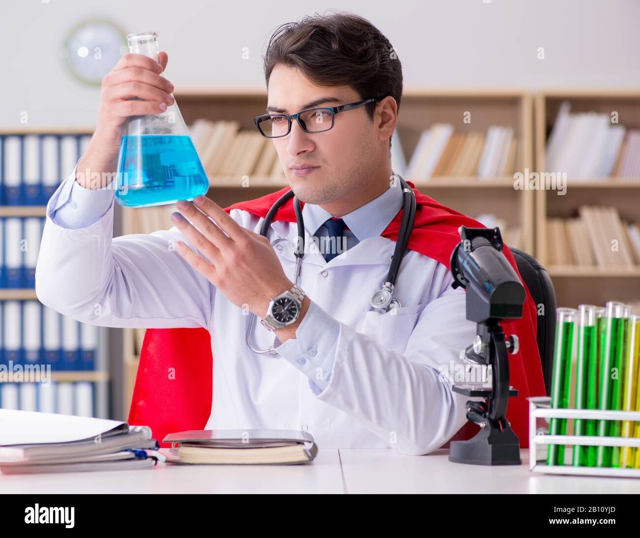 The superhero doctor working in the lab hospital Stock Photo - Alamy