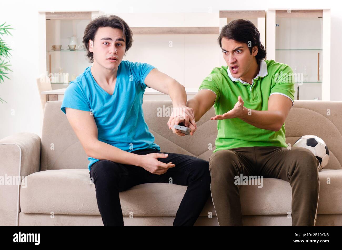 The friends watching football at home Stock Photo - Alamy