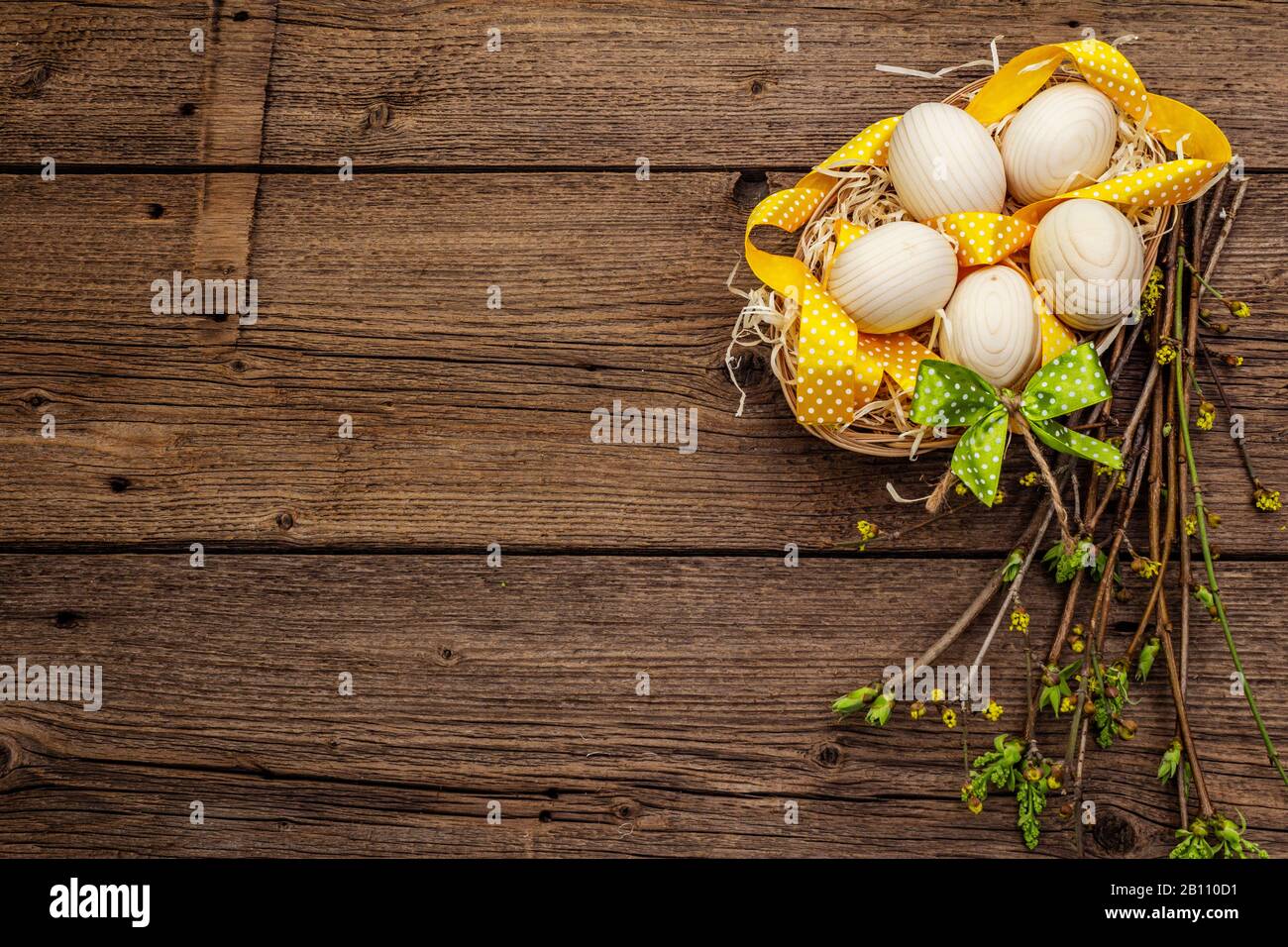 Zero waste Easter concept. Spring twigs with fresh green leaves, wooden ...