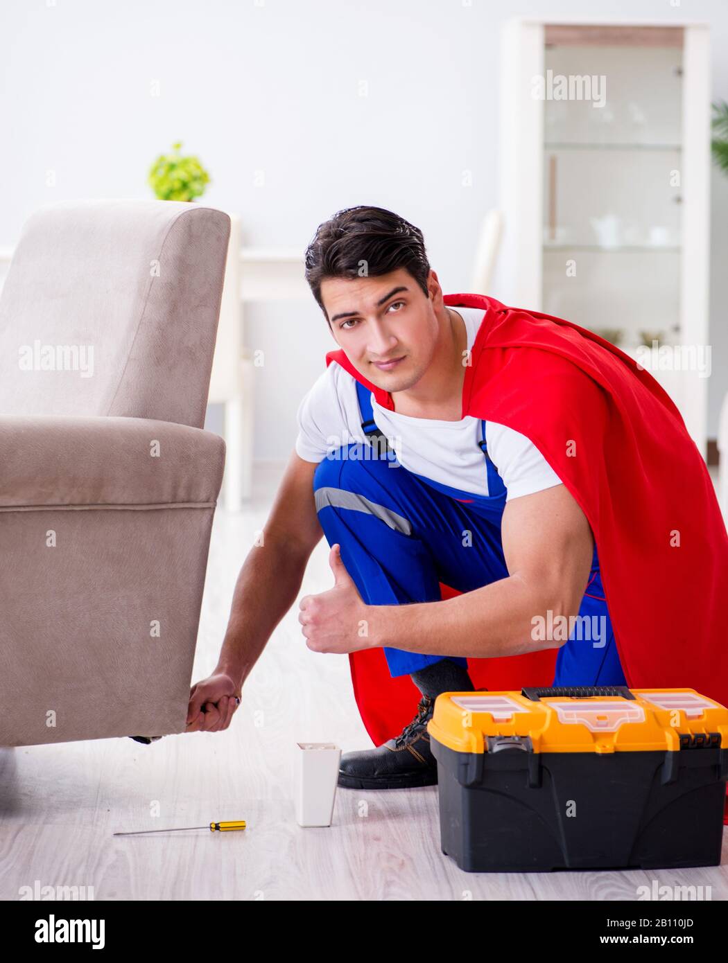 The superhero repairman with tools in repair concept Stock Photo - Alamy