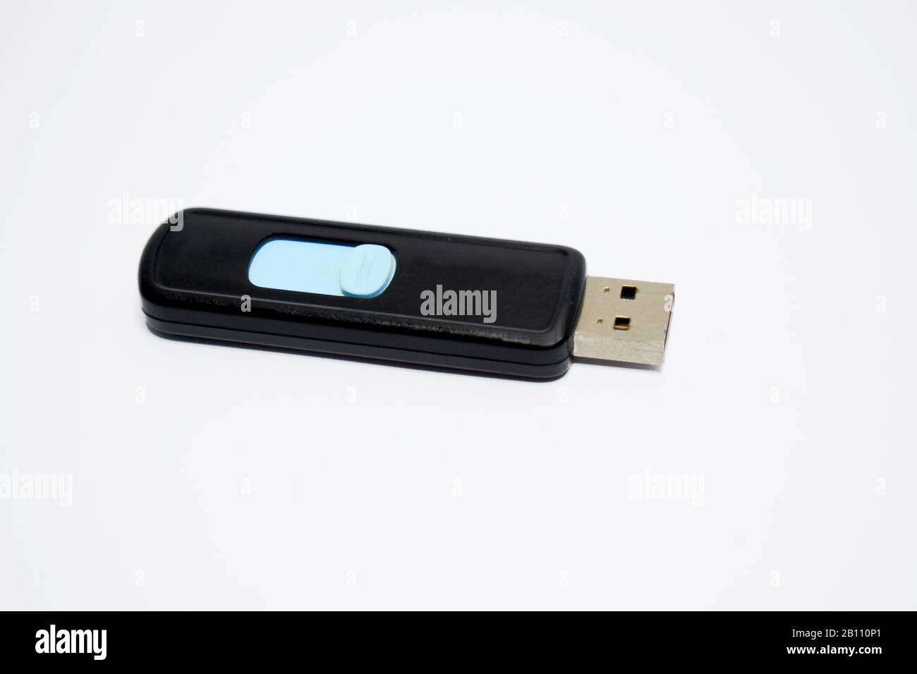 A blue and black colored pen drive placed on a white isolated ...
