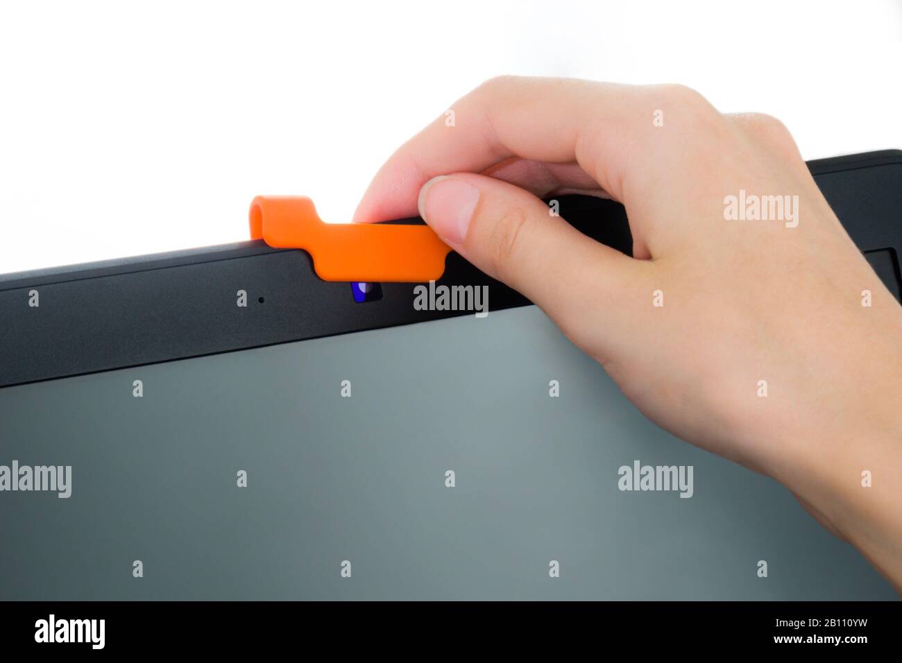 Human hand covering a webcam of laptop with rubber cover to prevent ...