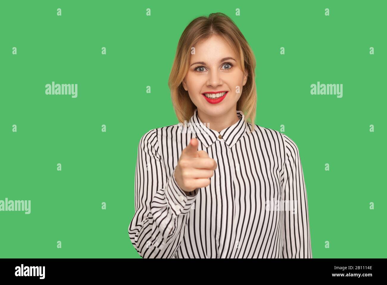 Hey you! Happy attractive blond girl in striped blouse pointing to ...