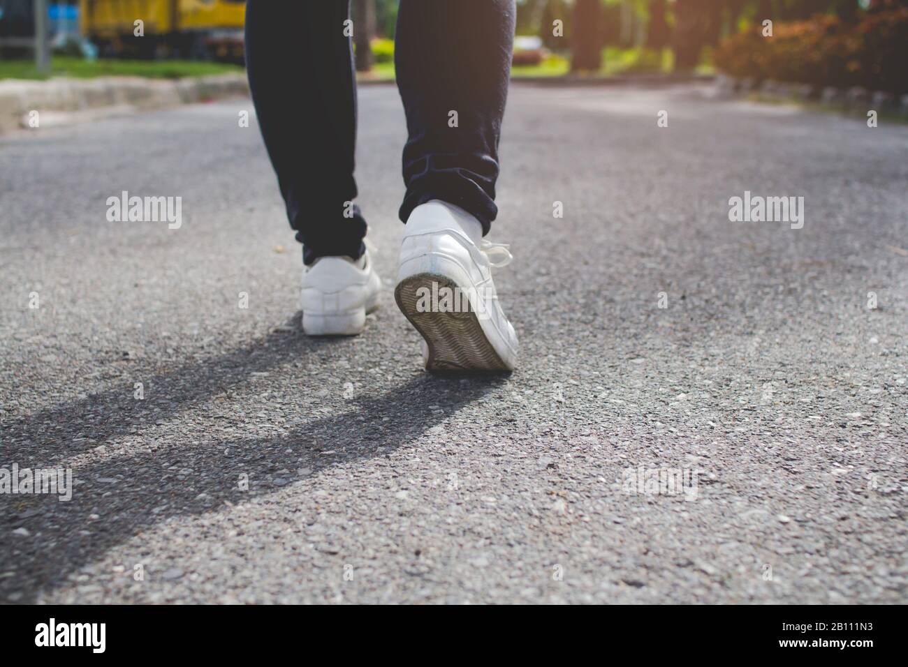 Step walk woman jeans and sneaker shoes walking on the road Stock Photo ...