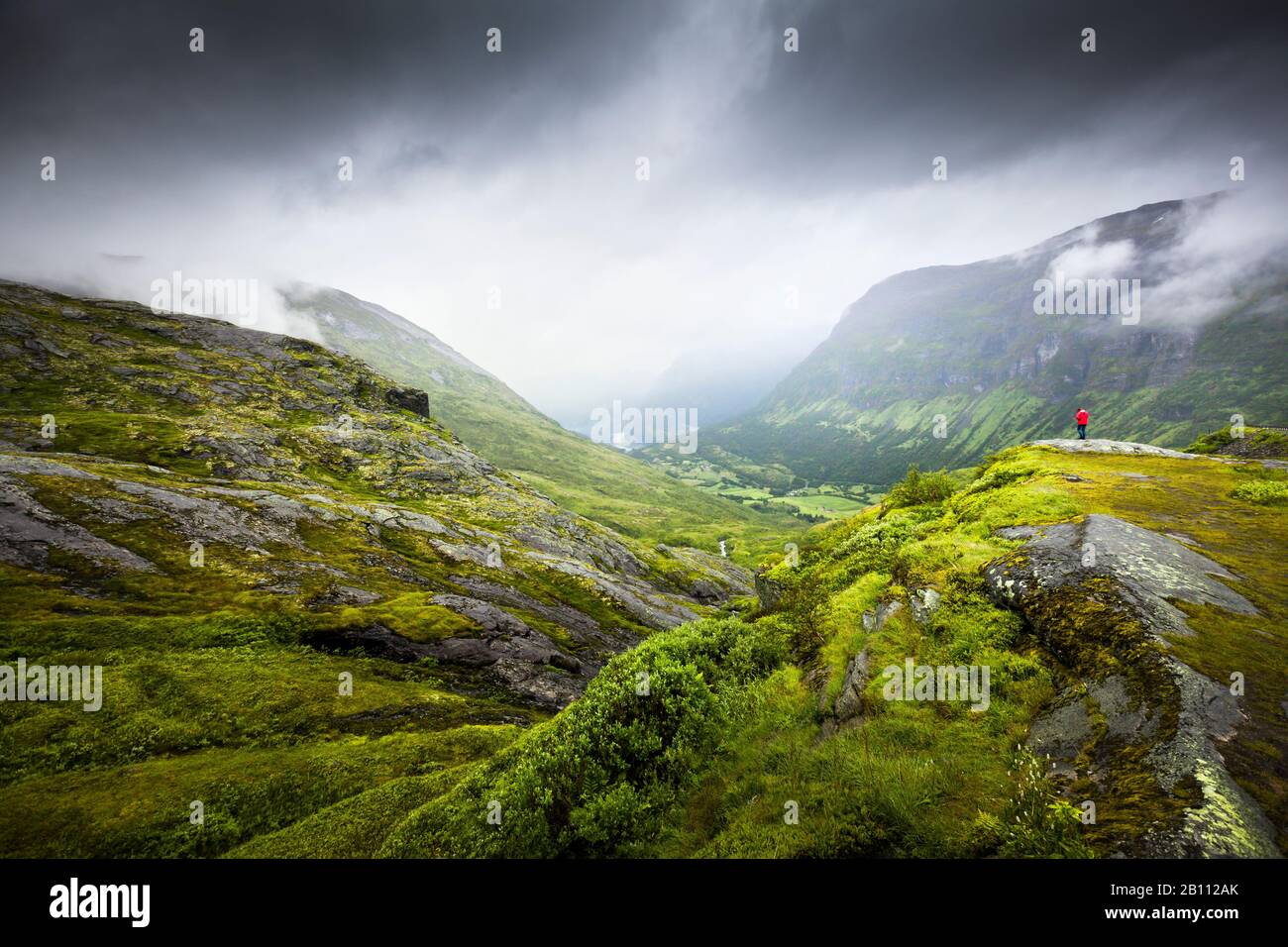 Single person on a ledge in the mountains, Geirangerfjord, Norway Stock ...