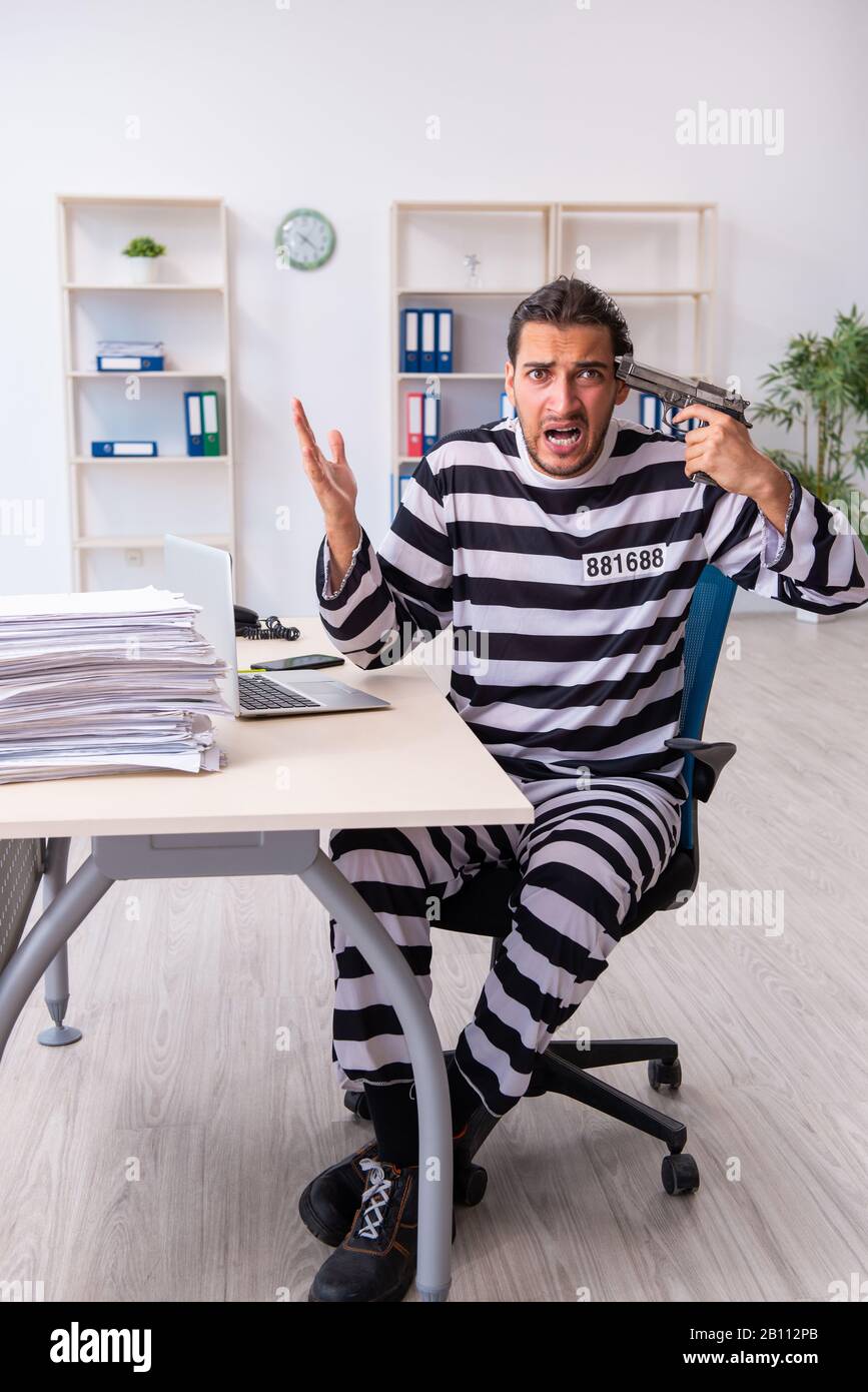 The young employee feeling like prisoner at work Stock Photo - Alamy