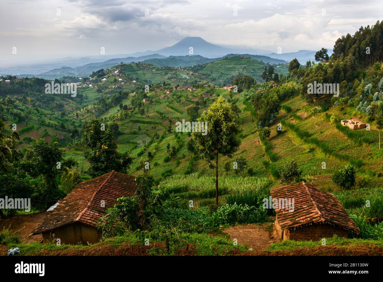 Village life and view of the Virunga volcanoes near Gisenyi, Rwanda ...