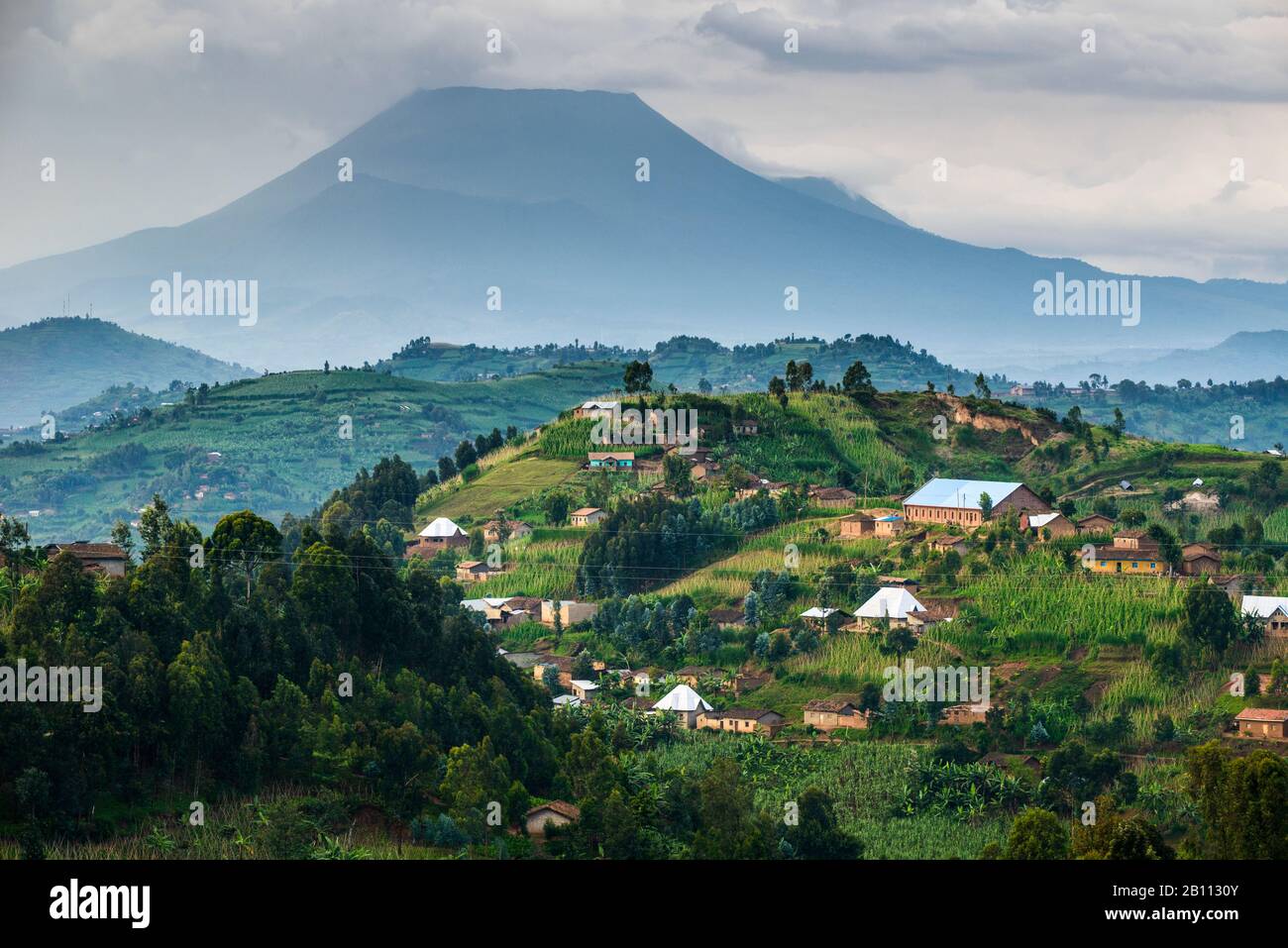 Village life and view of the Virunga volcanoes near Gisenyi, Rwanda ...