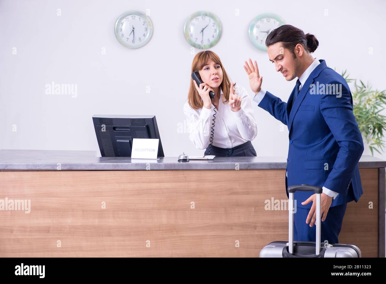 The young businessman at hotel reception Stock Photo - Alamy