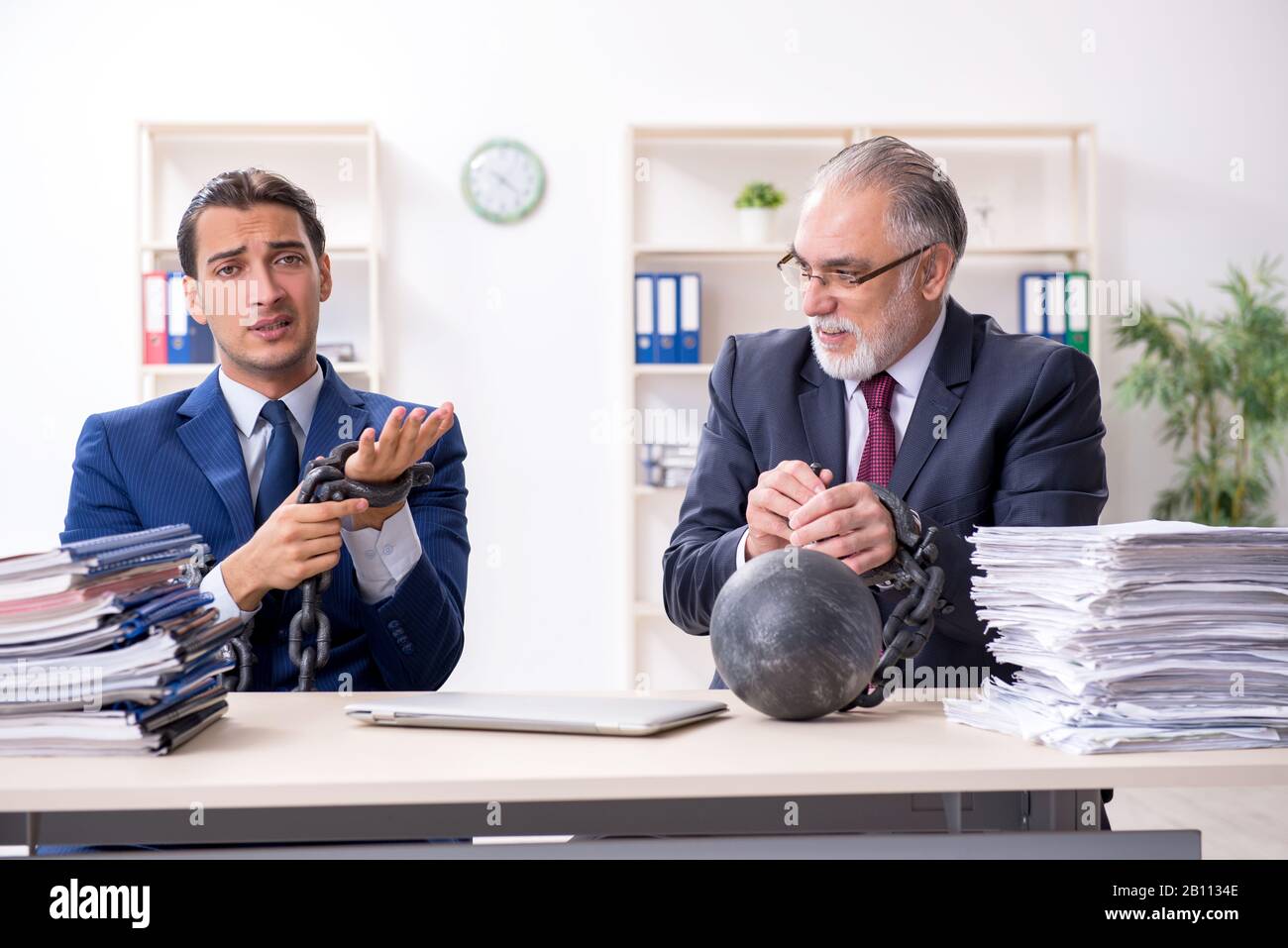 The two male employees unhappy with excessive work Stock Photo - Alamy