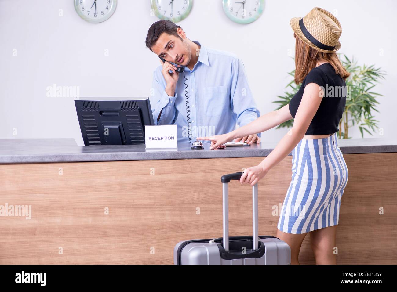 The young woman at hotel reception Stock Photo - Alamy