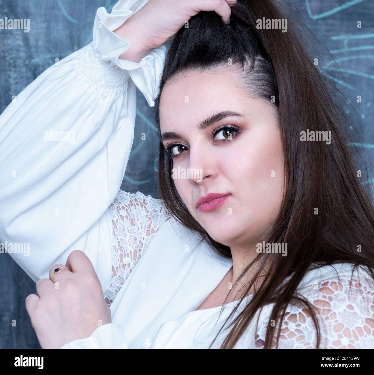 Charming girl in national Slavic clothes on a slate background, close ...