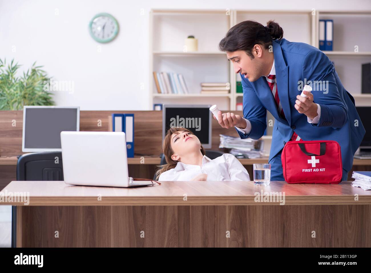 Employee receiving first aid in office Stock Photo - Alamy