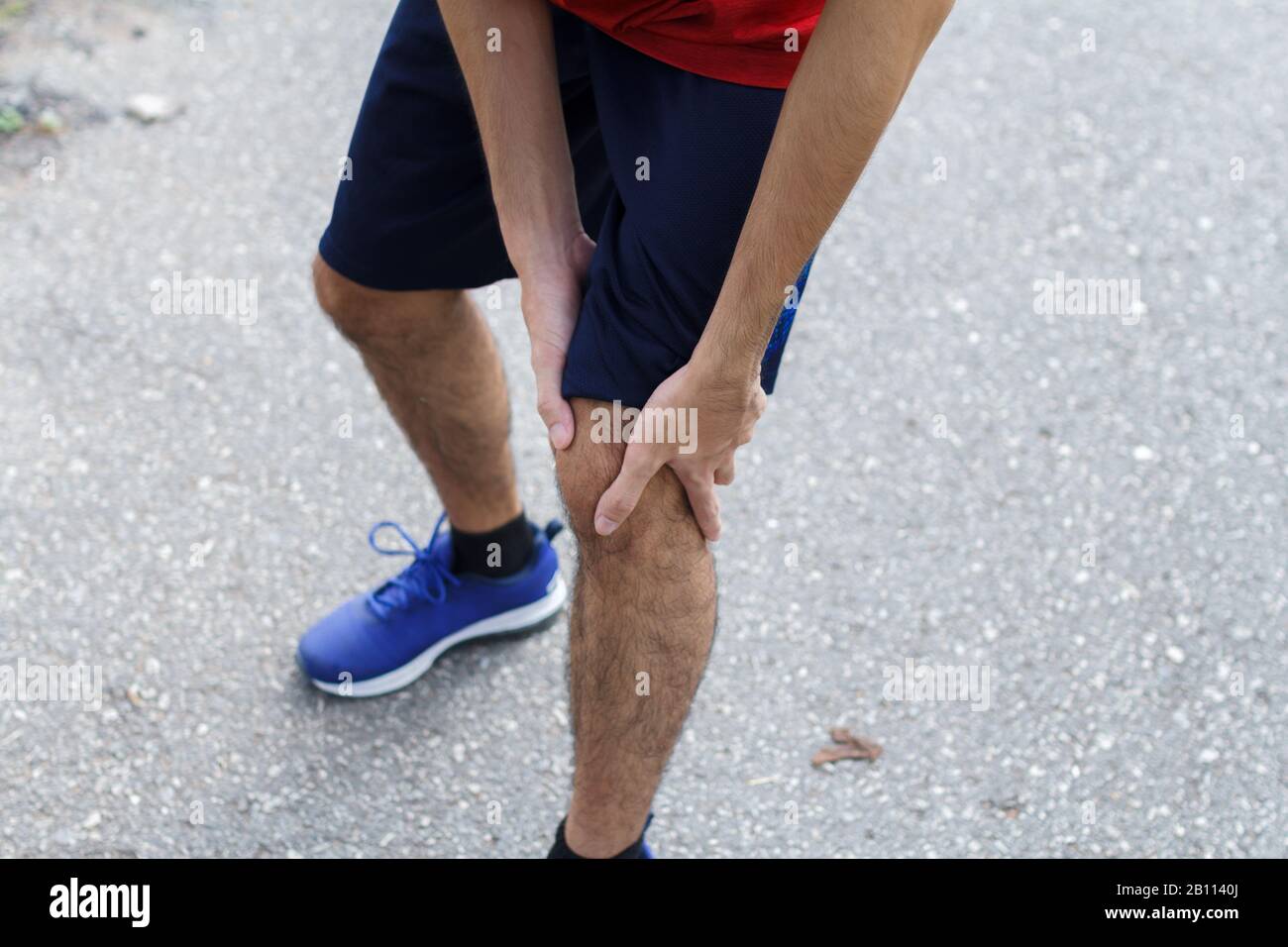 Close up of Sport man suffering with pain on sports running knee injury ...