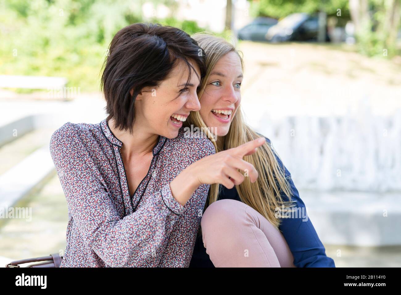 Two friends laugh together and talk Stock Photo - Alamy