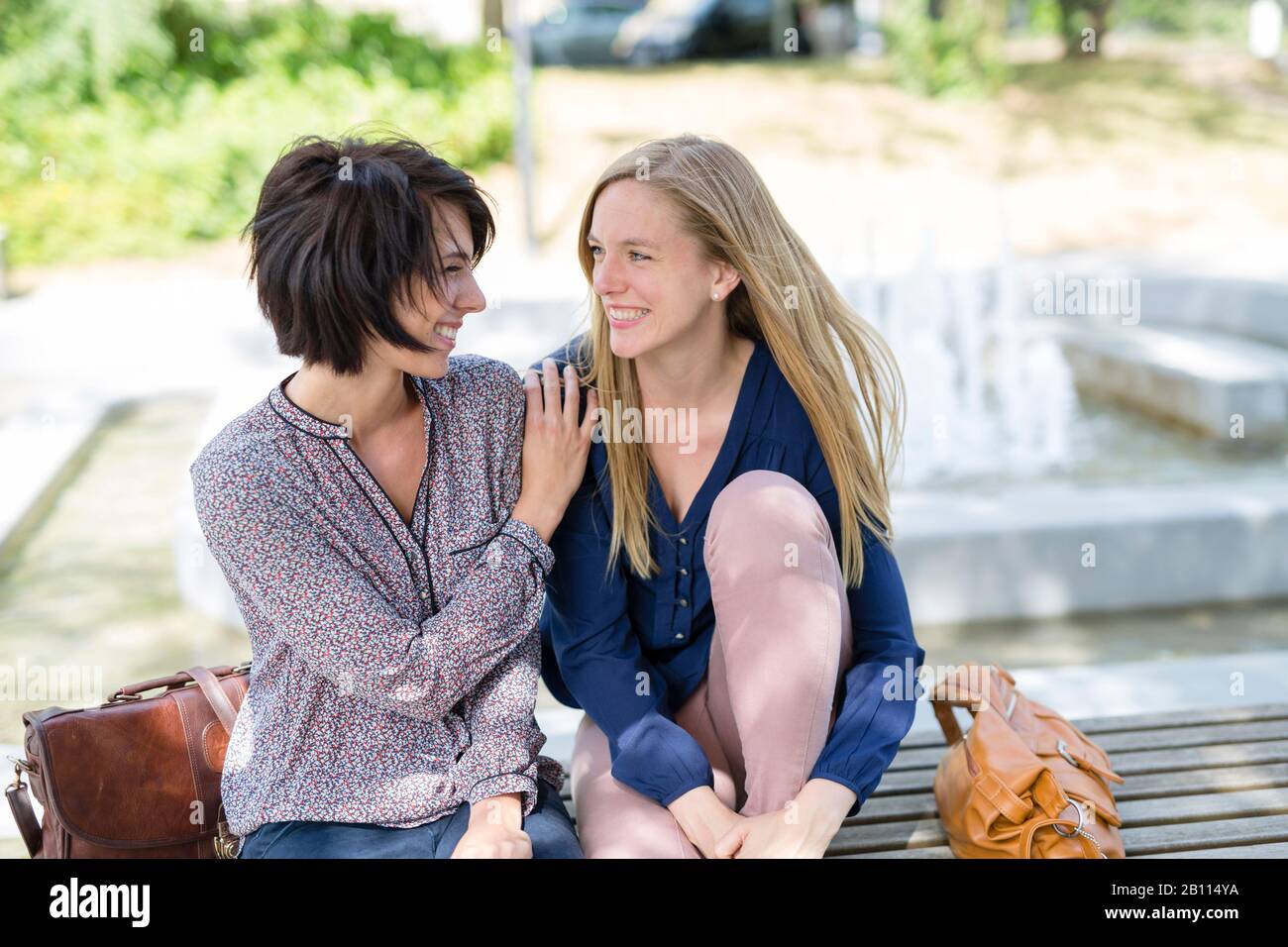Two friends laugh together and talk Stock Photo - Alamy