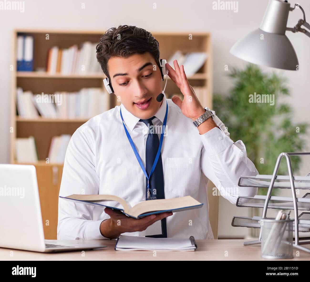 The handsome customer service clerk with headset Stock Photo - Alamy
