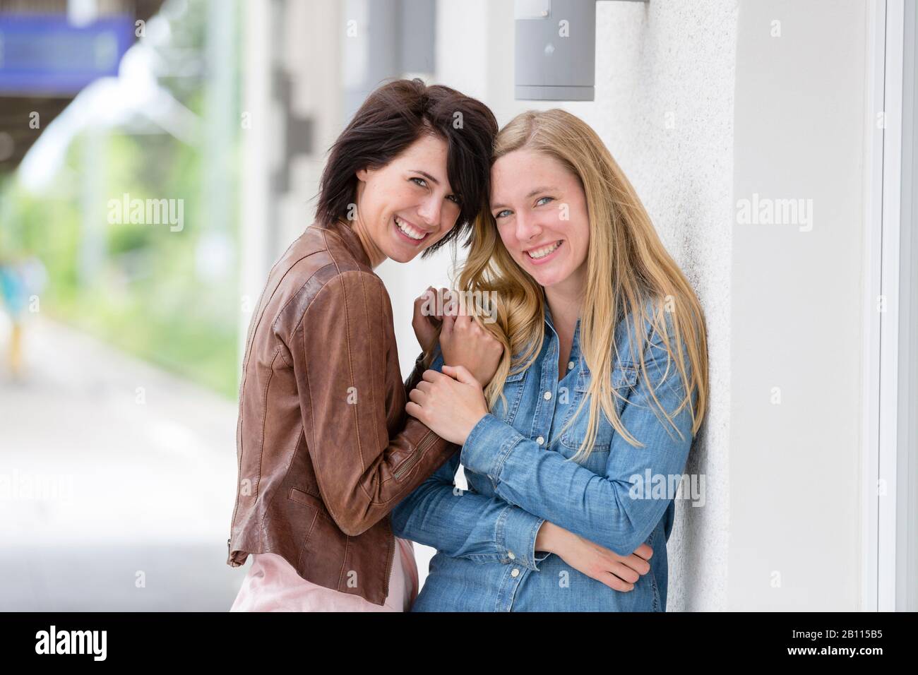 Two friends laugh together and talk Stock Photo - Alamy