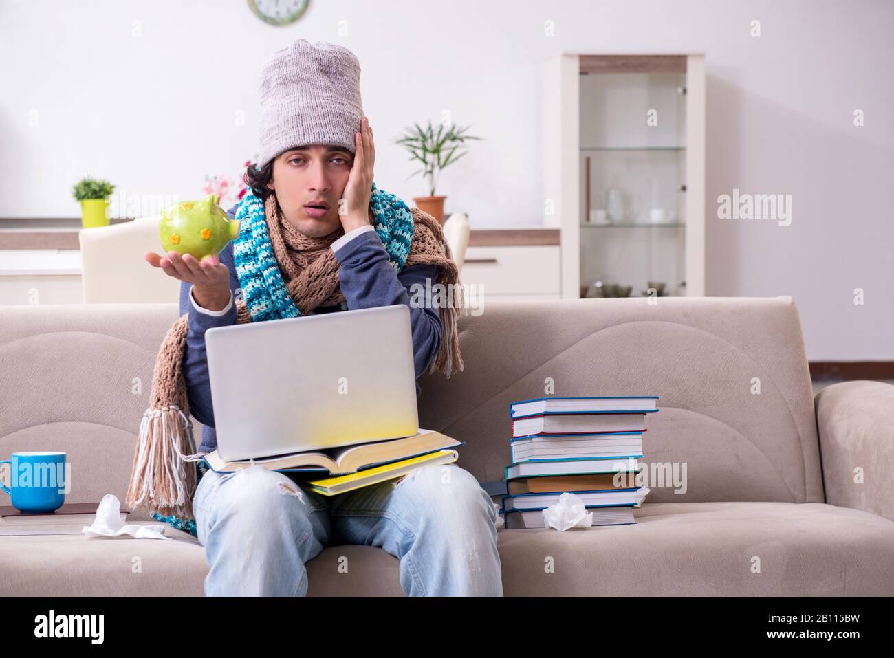 The sick male student suffering at home Stock Photo - Alamy