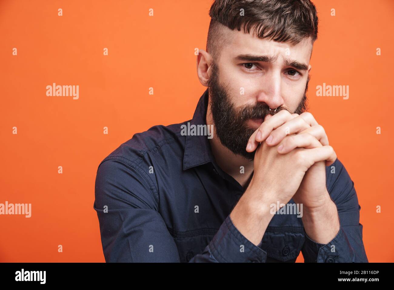 Image closeup of uptight man with nose jewelry wearing black shirt ...