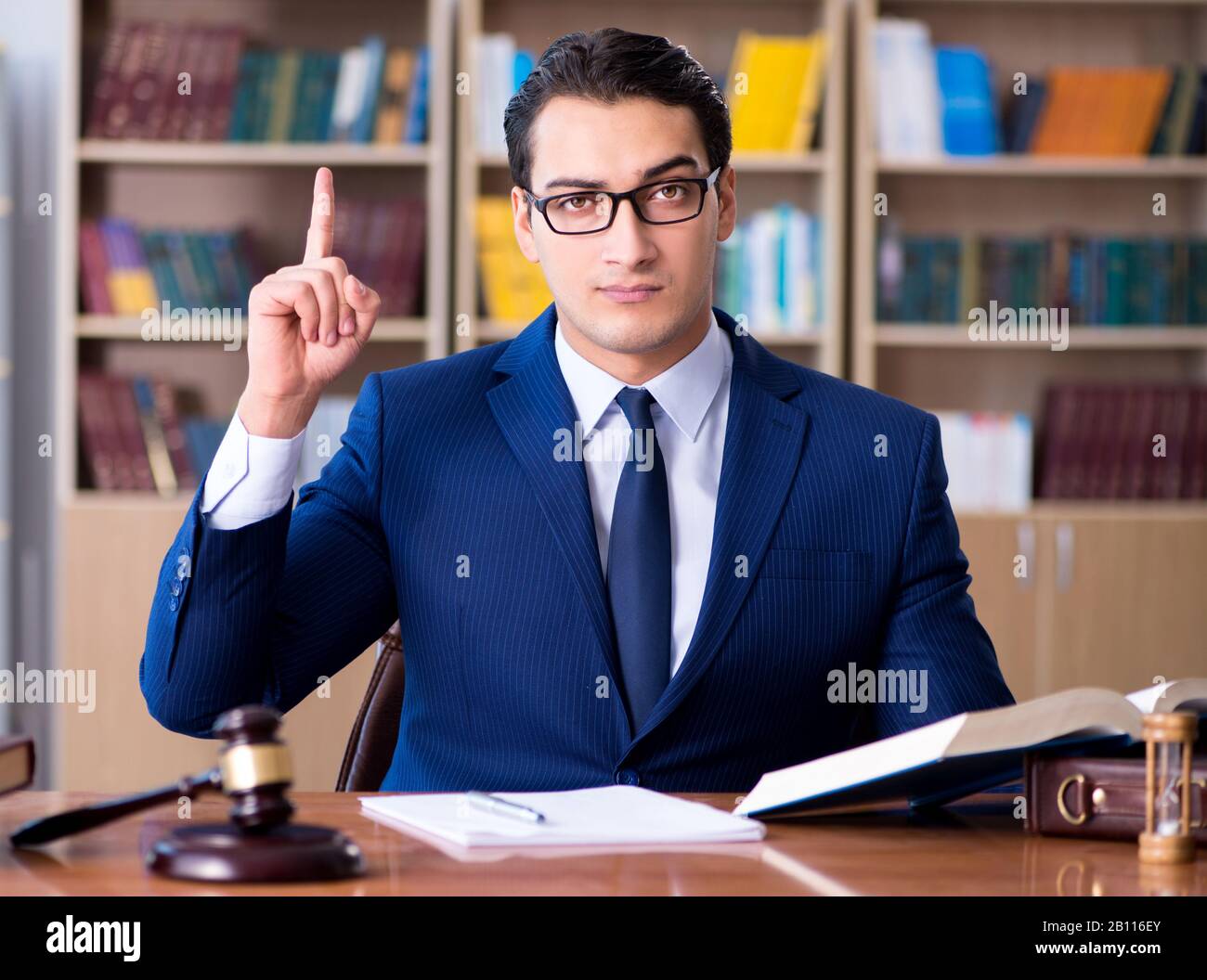 The handsome judge with gavel sitting in courtroom Stock Photo - Alamy