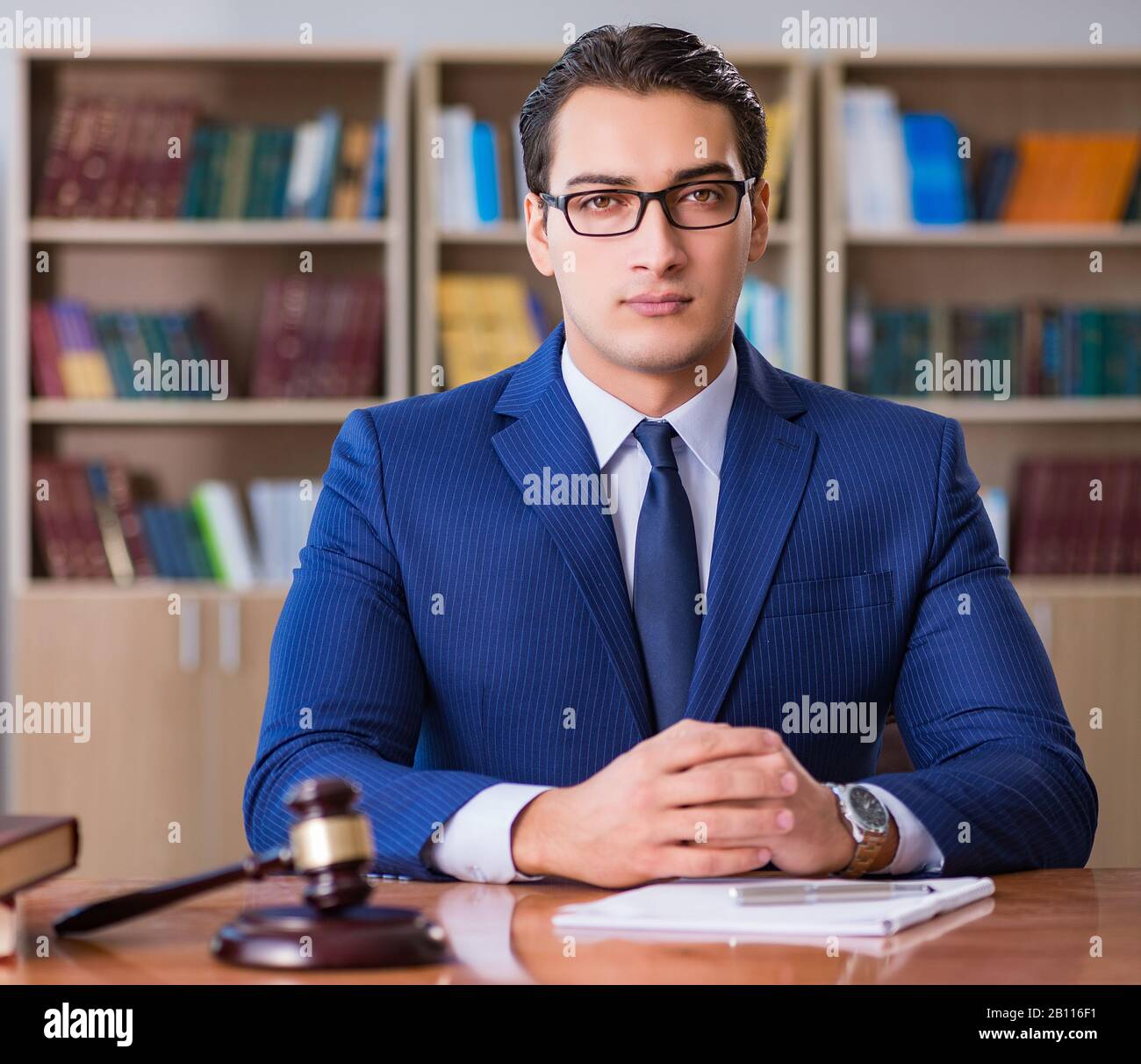 The handsome judge with gavel sitting in courtroom Stock Photo - Alamy