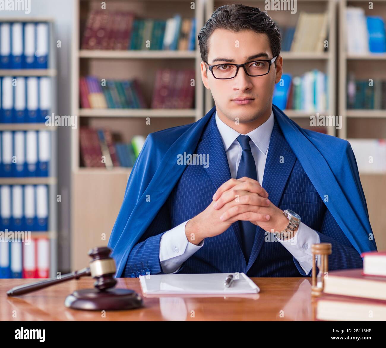 The handsome judge with gavel sitting in courtroom Stock Photo - Alamy