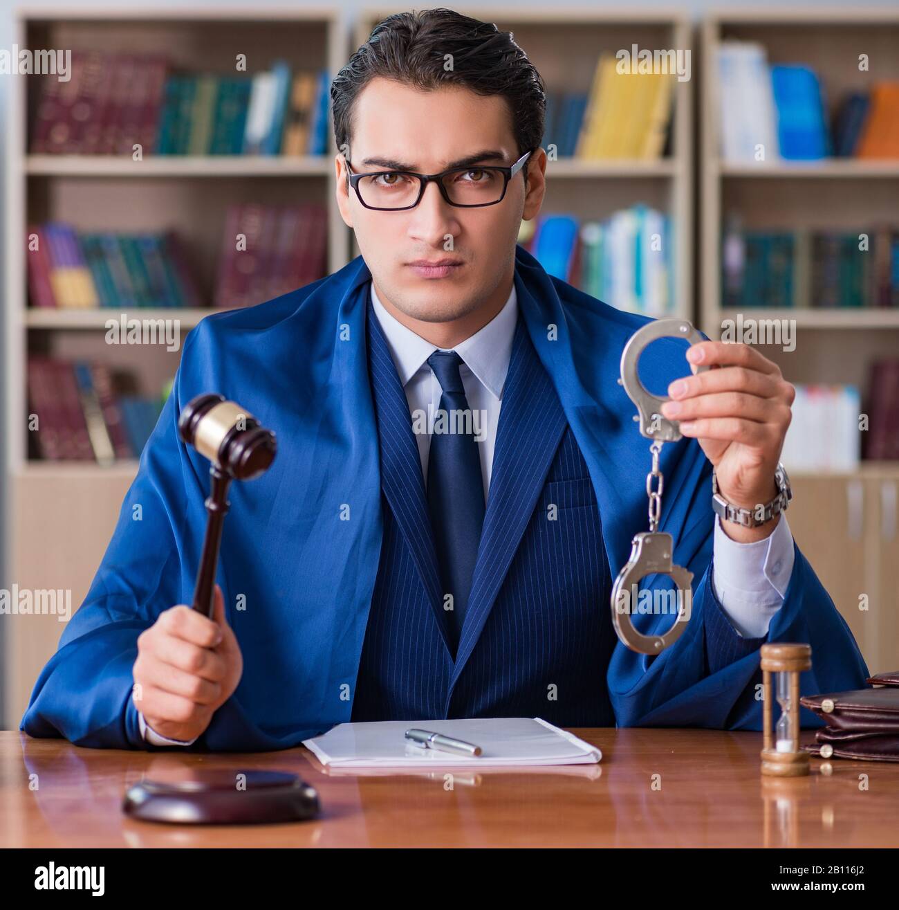 The handsome judge with gavel sitting in courtroom Stock Photo - Alamy