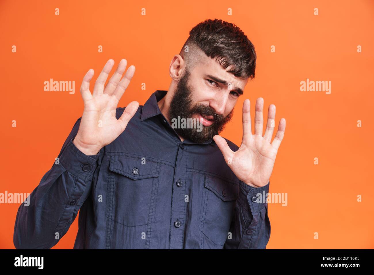 Image closeup of nervous man with nose jewelry wearing black shirt ...