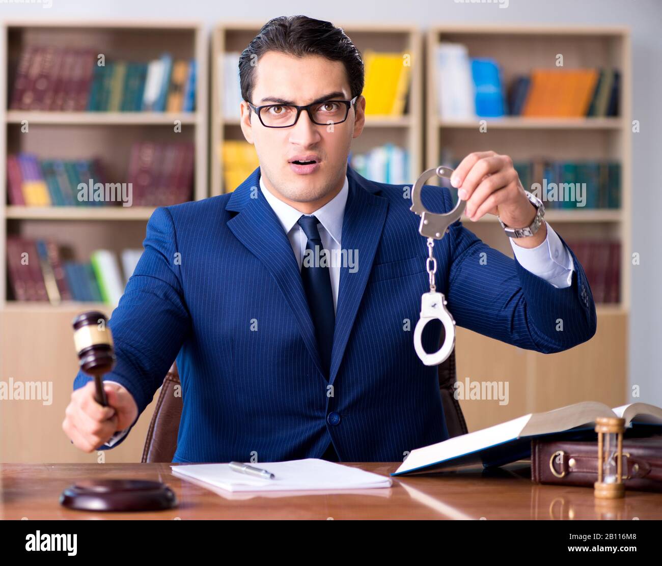 The handsome judge with gavel sitting in courtroom Stock Photo - Alamy