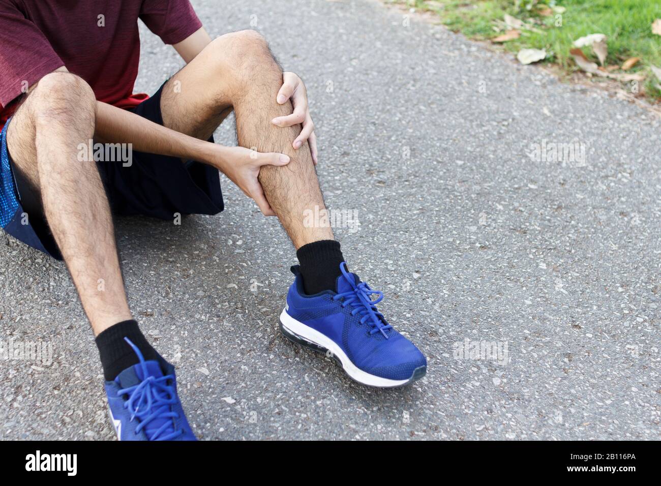 Close up of sport man suffering with pain on sports running knee injury ...