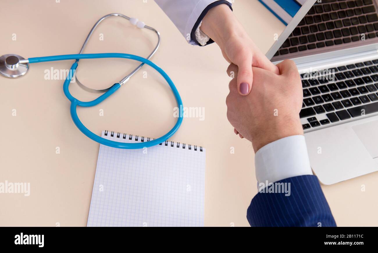The man signing medical insurance contract Stock Photo - Alamy